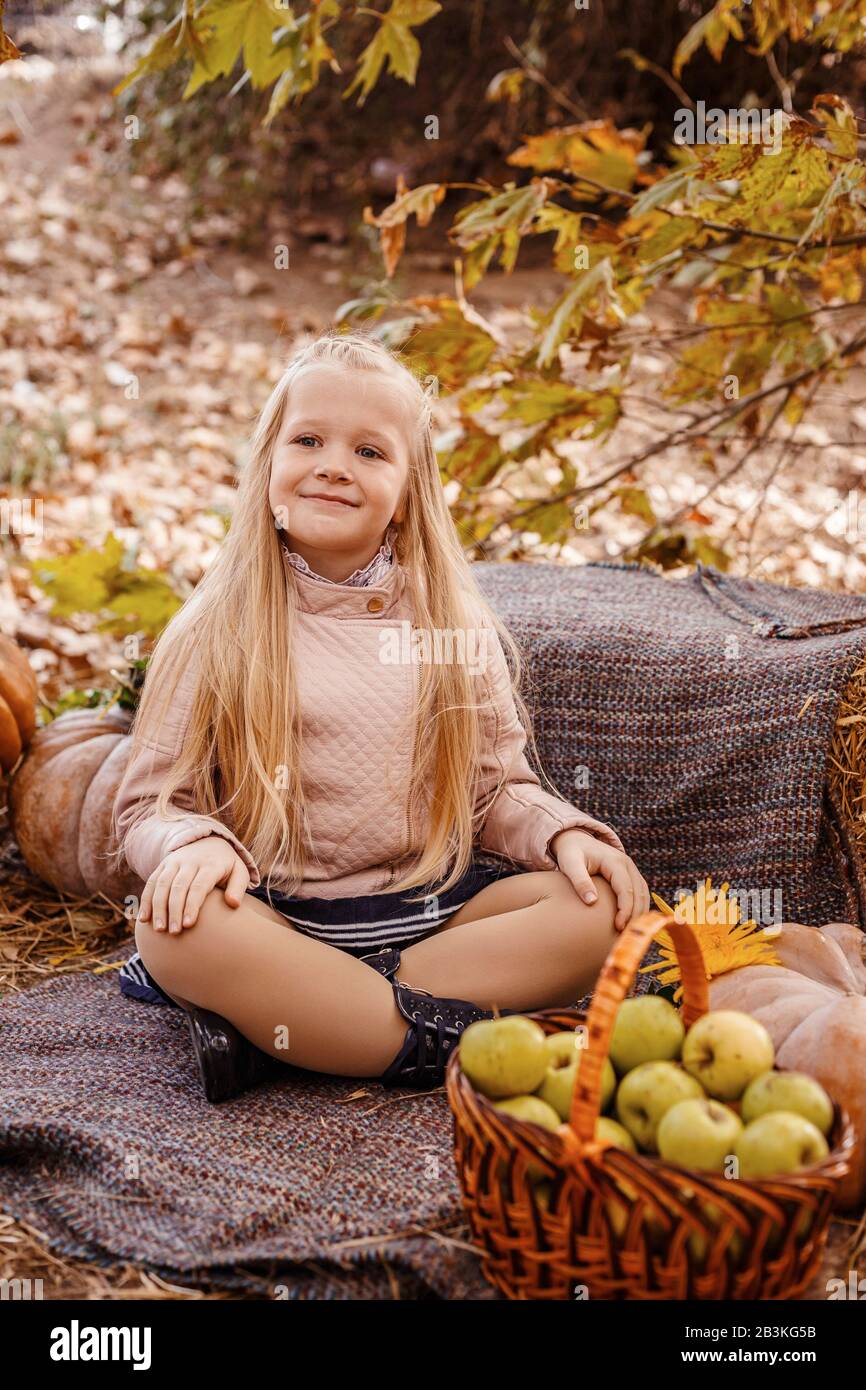 Happy cute girl in autumn fall outdoor. Celebrate harvest festival. Kid ...