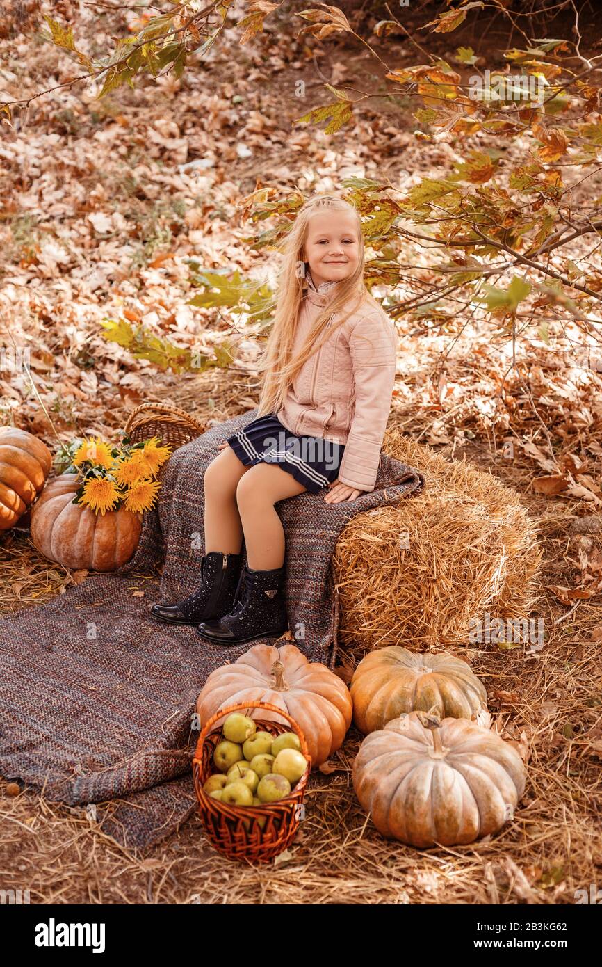 Happy cute girl in autumn fall outdoor. Celebrate harvest festival. Kid ...