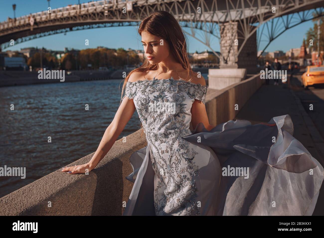 Beautiful young woman in a interesting dress posing in the art space ...