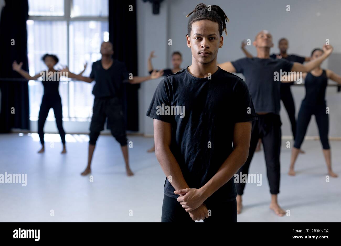 Mixed race modern male dancer looking at camera Stock Photo - Alamy