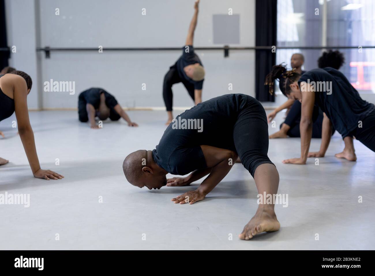 Group of modern dancers stretching up in a studio Stock Photo - Alamy