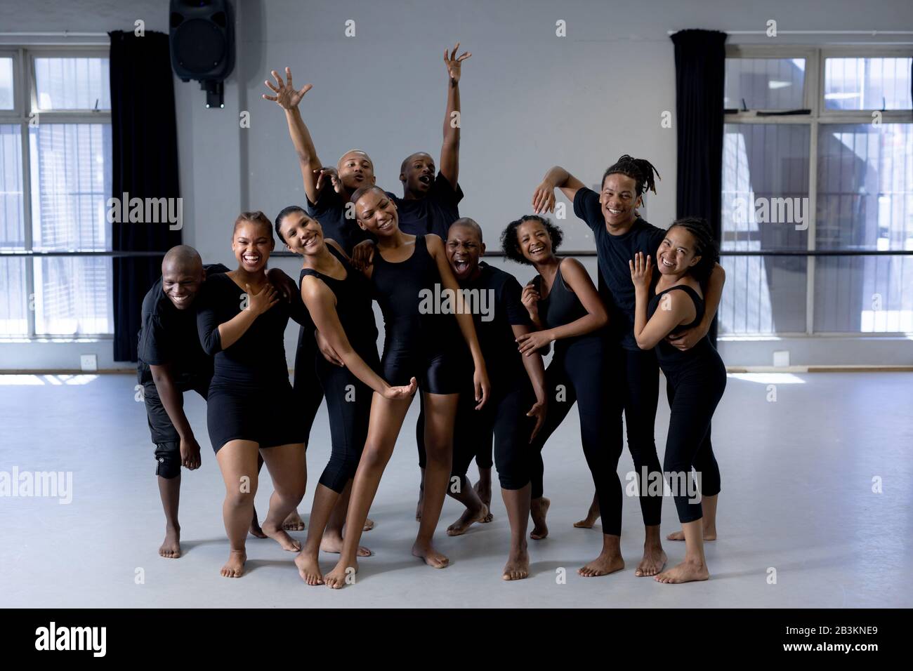 Group of modern dancers smiling and looking at camera in a studio Stock ...