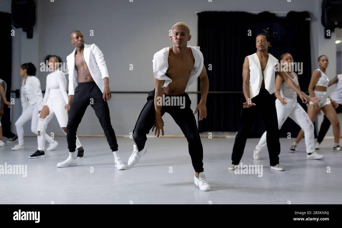 Mixed race modern dancers practicing a dance routine in a studio Stock ...