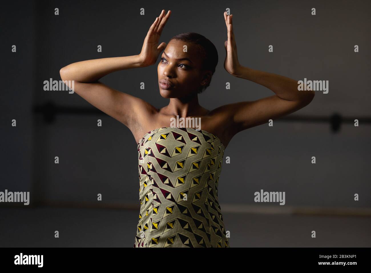Mixed race female dancer wearing yellow dress Stock Photo - Alamy