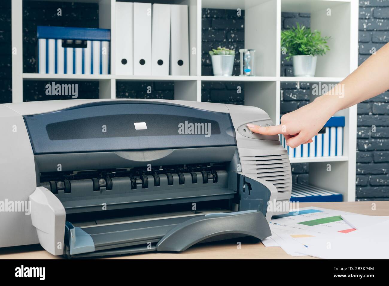 Woman making photocopy using copier in office Stock Photo - Alamy