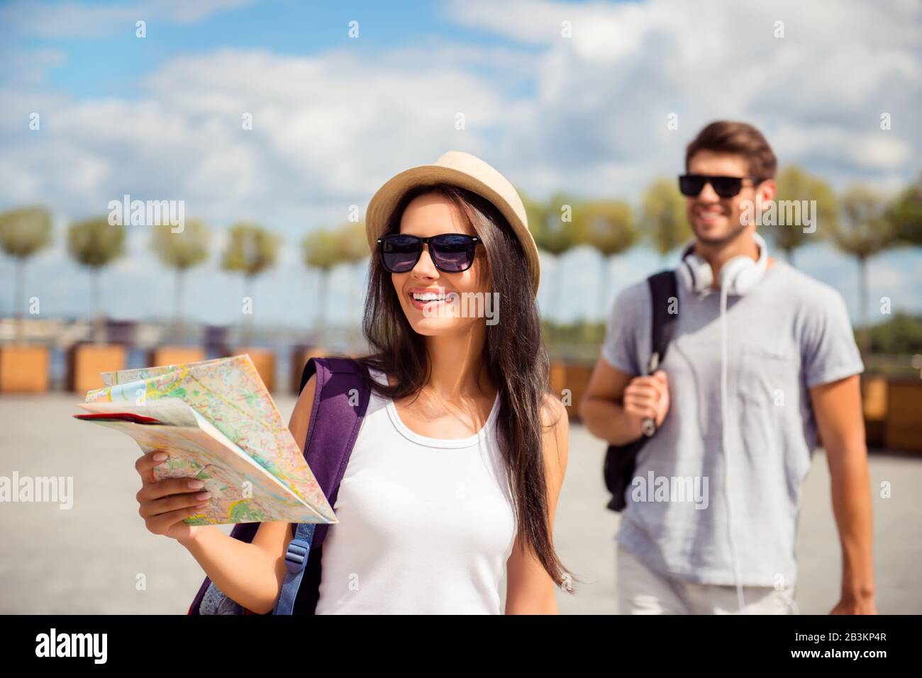 Young smiling people searching for direction using paper map Stock ...