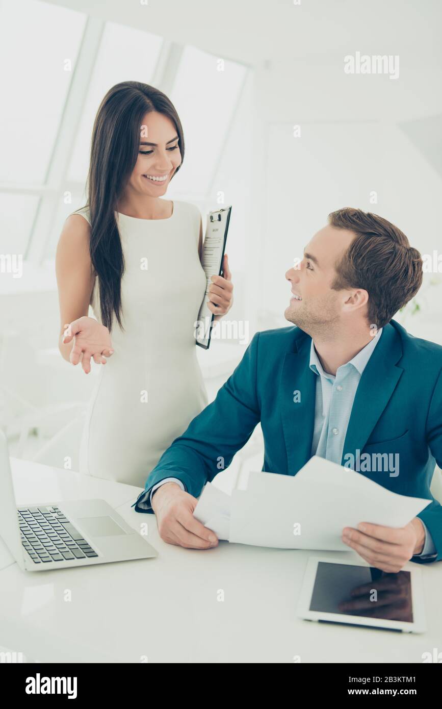 Young woman offering help with contract to her colleague Stock Photo ...