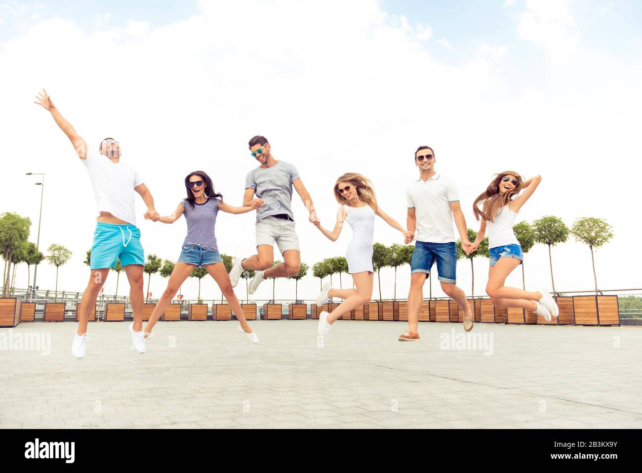joyful happy best friends having fun and jumping Stock Photo - Alamy