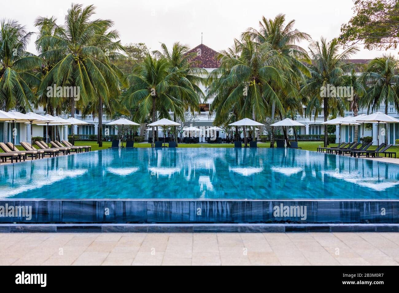 Sunbathing deck with umbrella swimming pool hotel resort beach ...