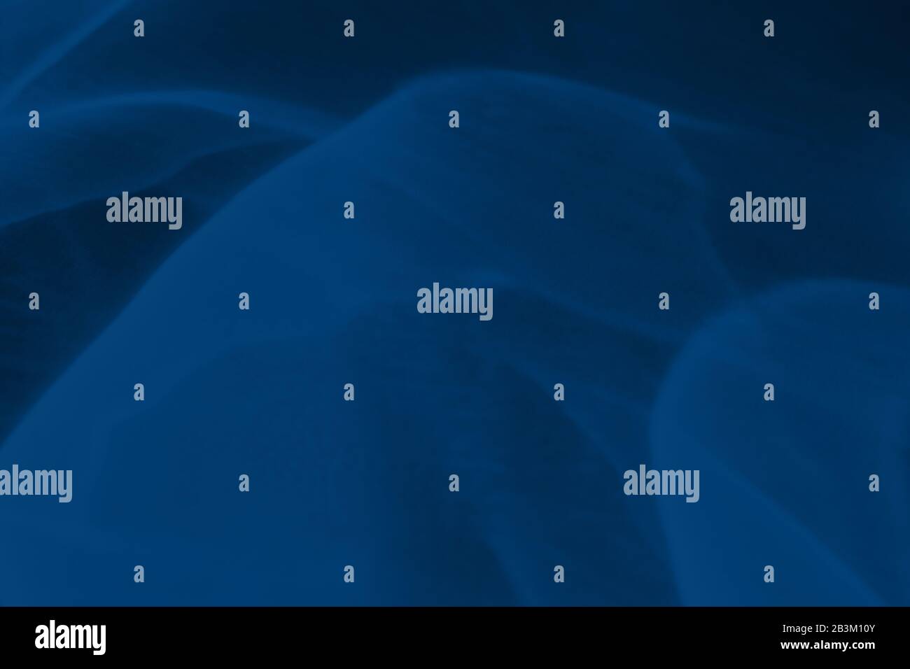 blue colored abstract background with light and shadows caustic effect ...