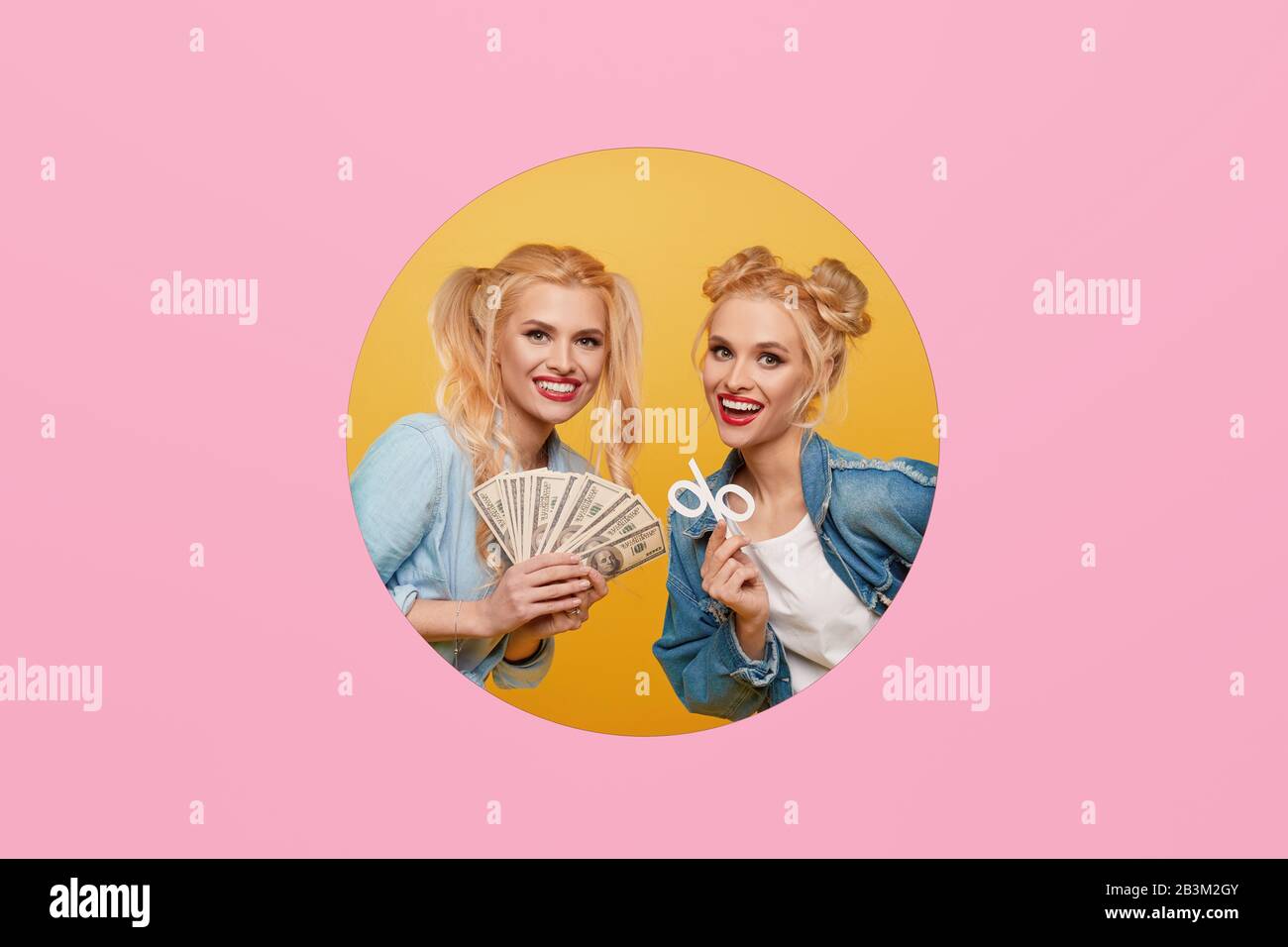 Two young shocked women with a bundle of banknotes money, text Sale and ...