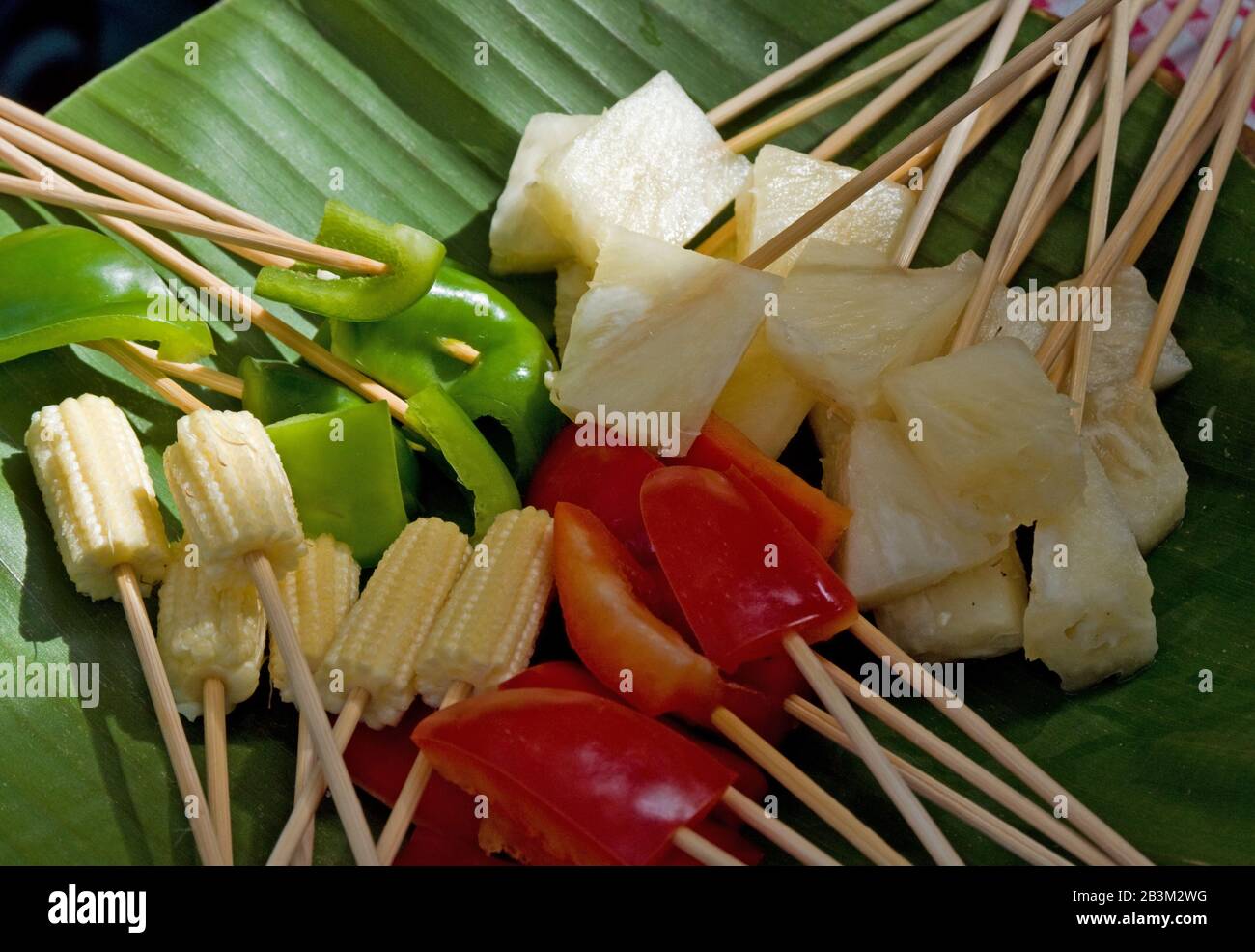 Fresh Pine apple Paprika And Sweet Corn nubbin Are Set On The Sticks And Served On The Banana fresh-pine-apple-paprika-and-sweet-corn-nubbin-are-set-on-the-sticks-and-served-on-the-banana