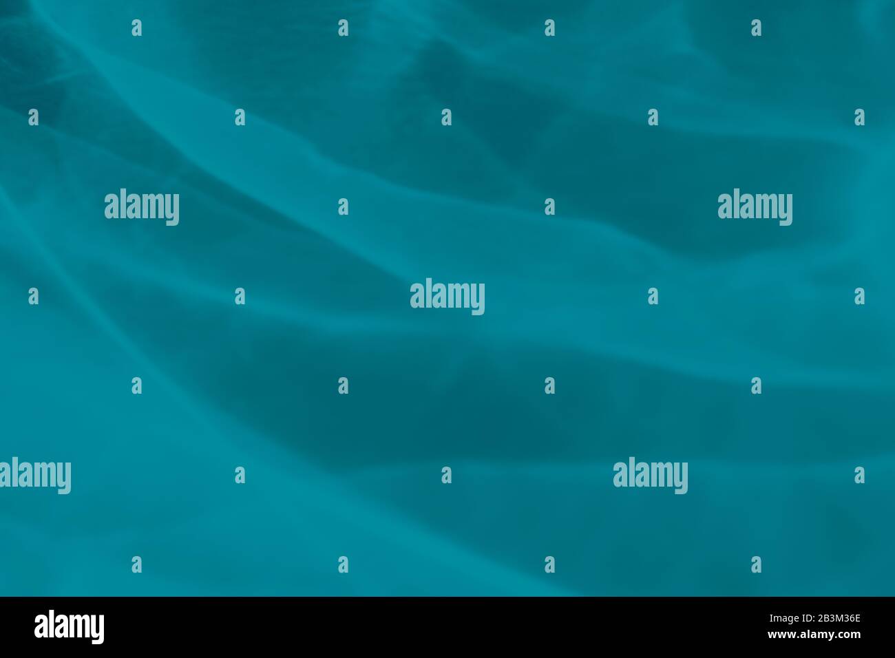 Blue colored abstract background with light and shadows caustic effect ...