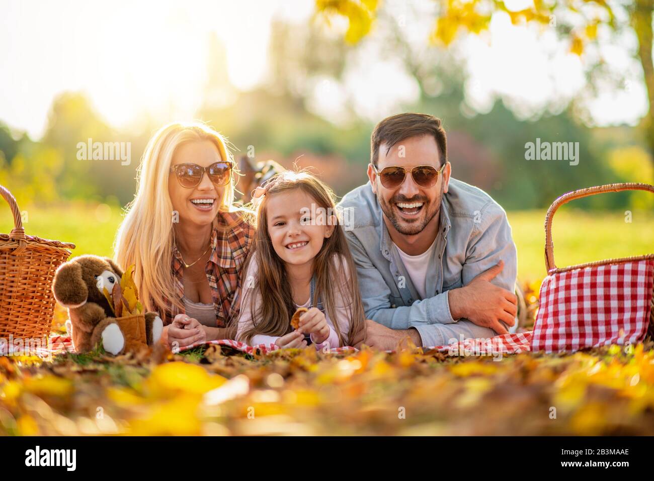 Happy family having picnic in nature.Smiling family picnicking in the ...
