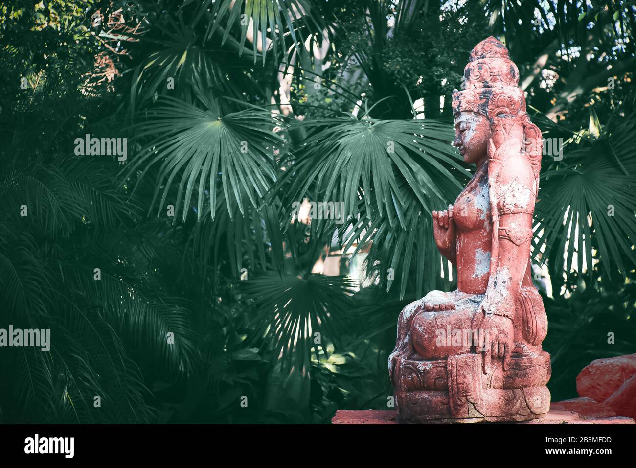 Buddha. Asian inspiration figure surrounded by lush nature Stock Photo ...