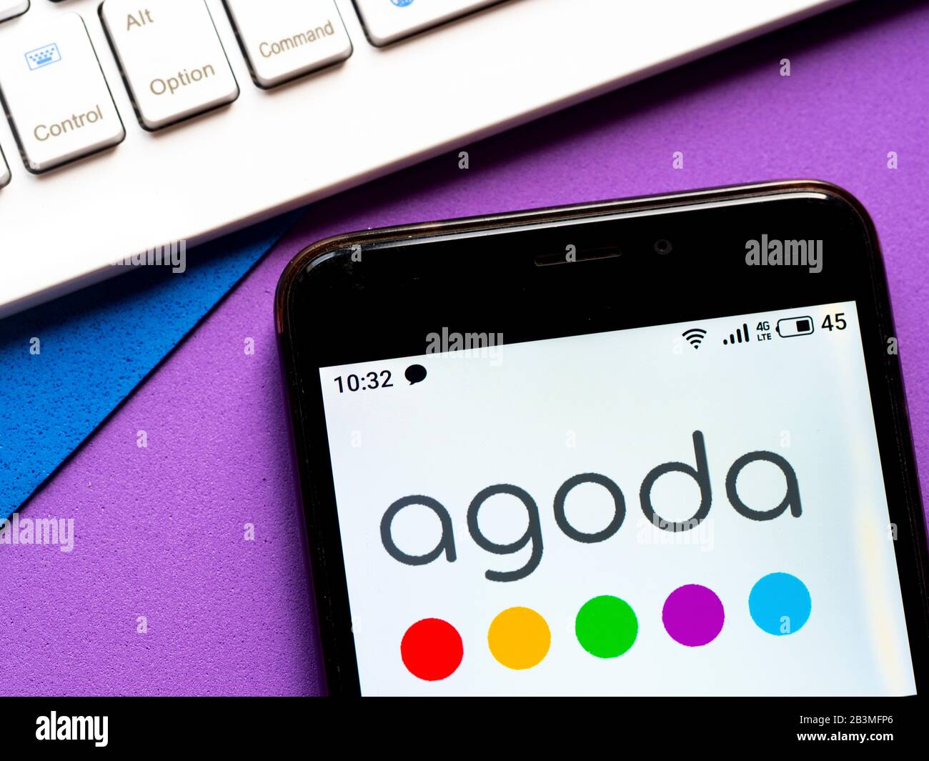 In this photo illustration an agoda logo seen displayed on a smartphone ...
