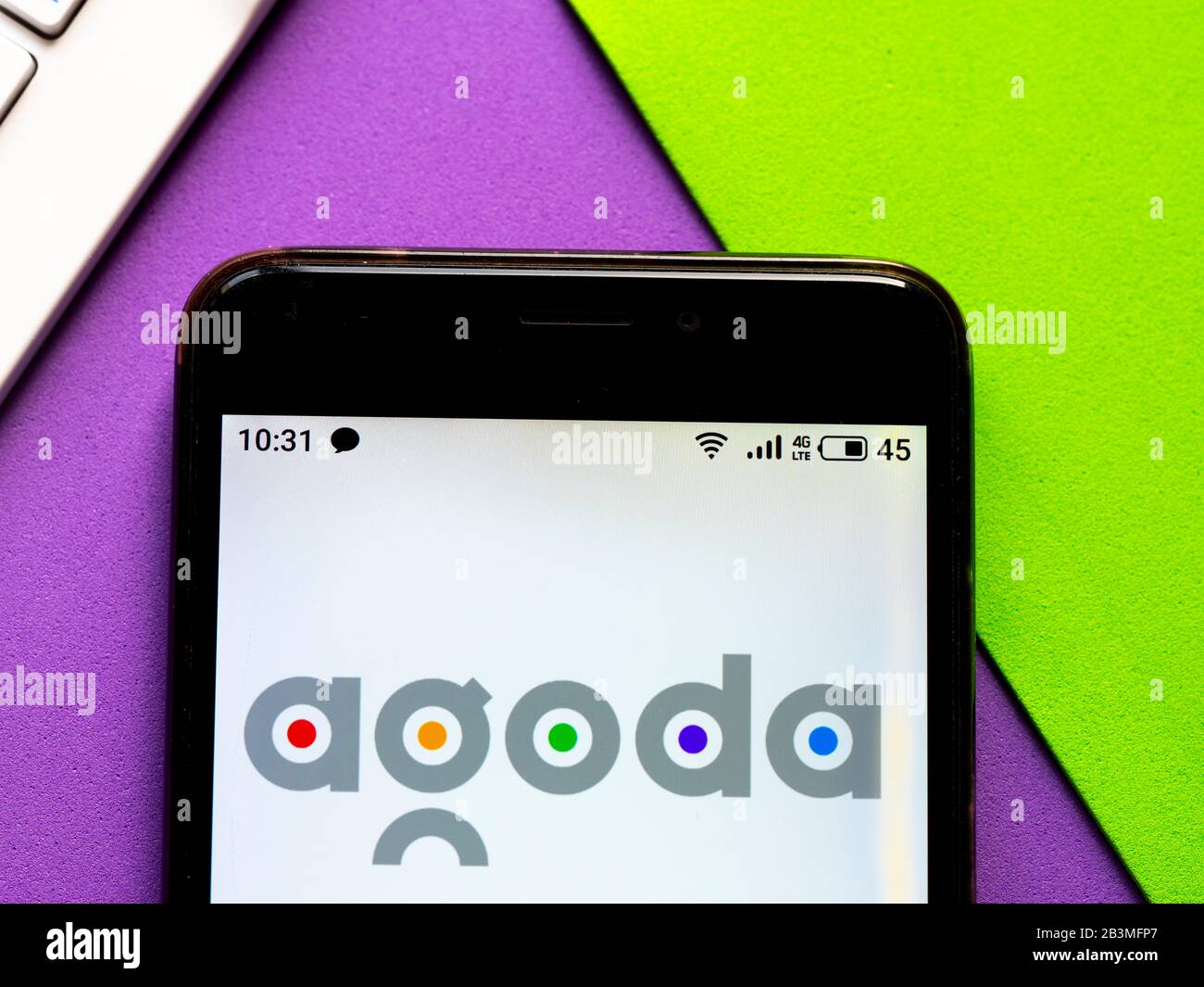 In this photo illustration an agoda logo seen displayed on a smartphone ...