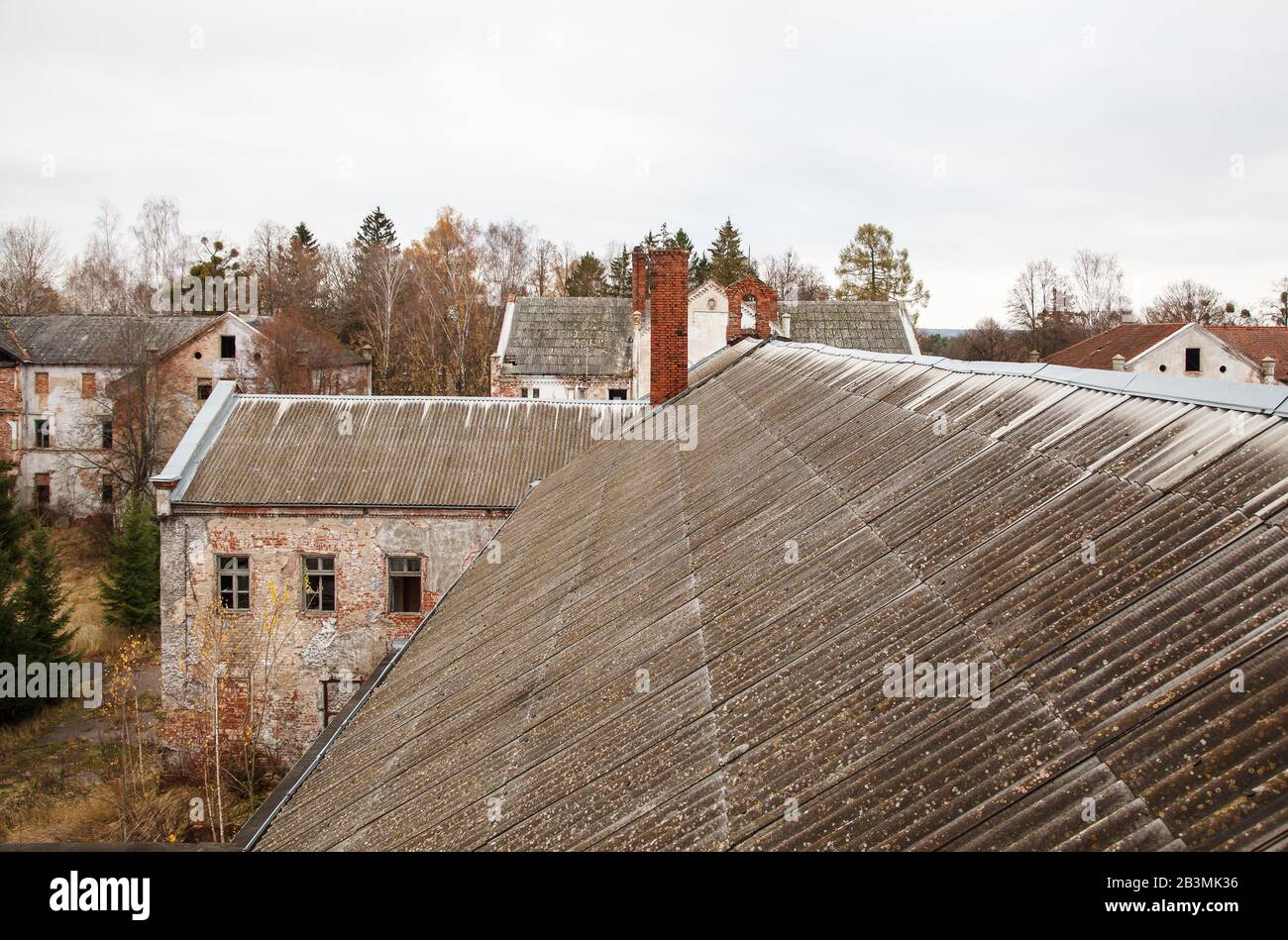 old buildings of an abandoned psychiatric hospital on gloomy autumn day ...