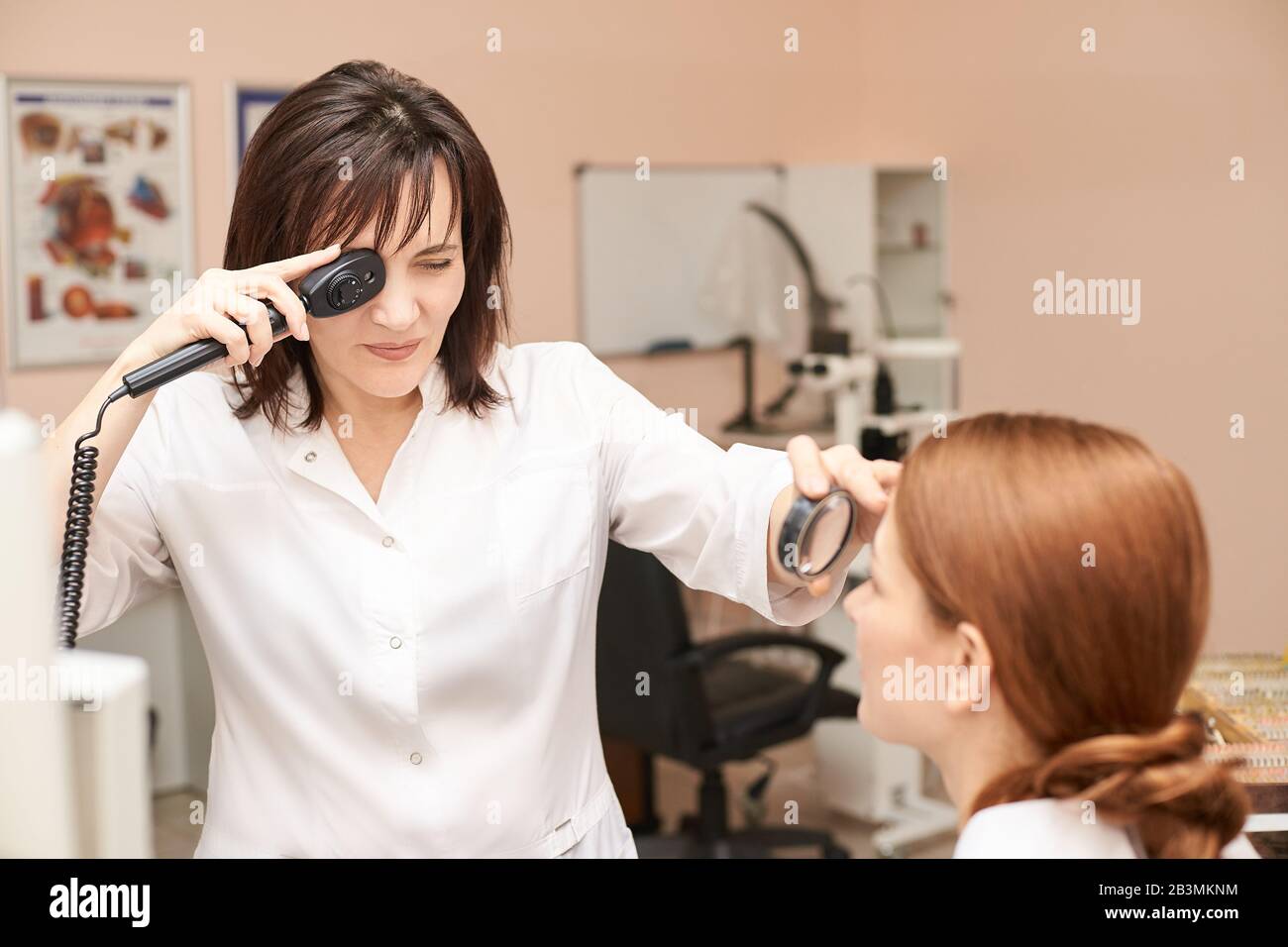 ophthalmologist doctor in exam optician laboratory with female patient ...