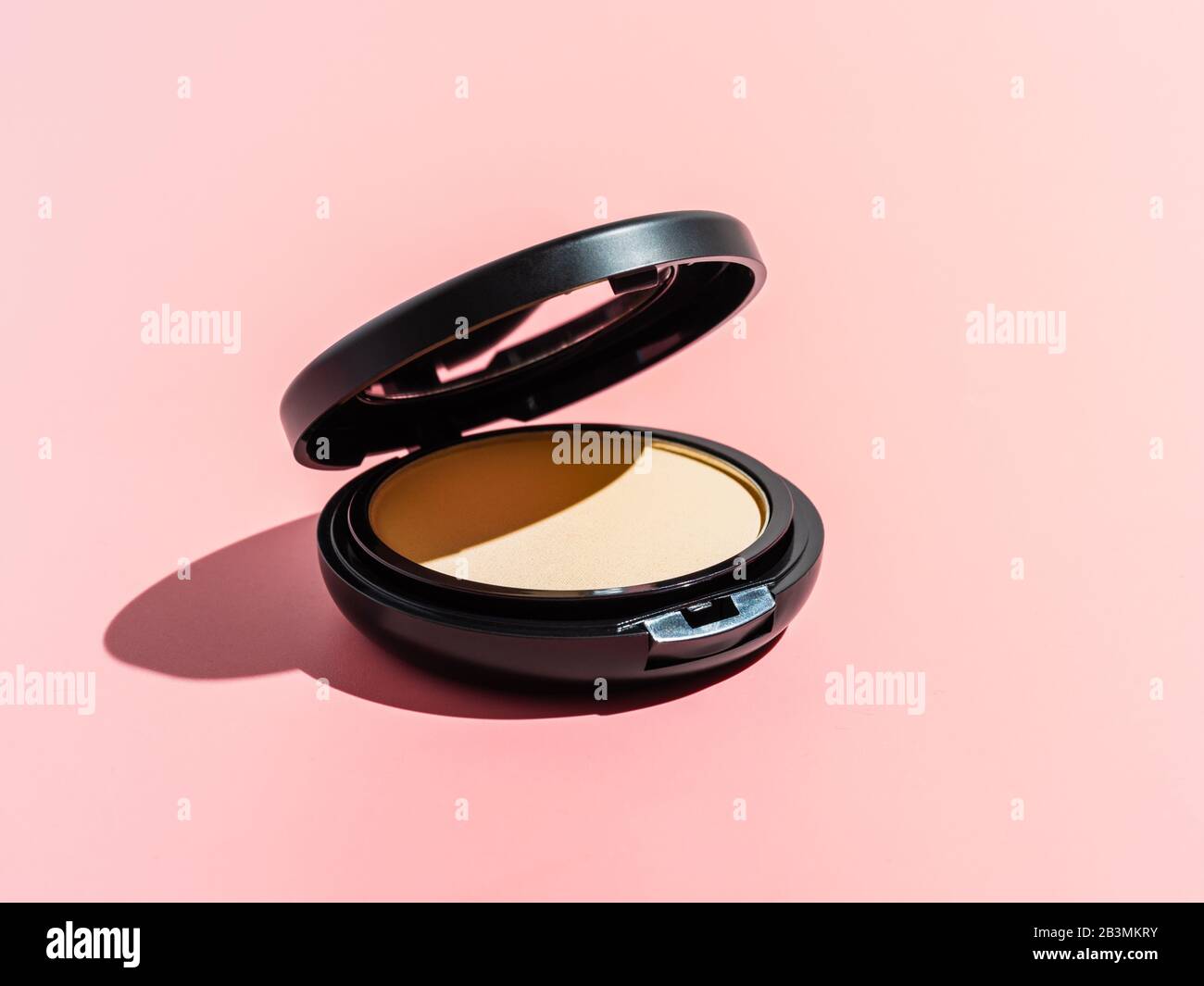 Compact powder on pink background. Female pressed powder in ajar opened ...