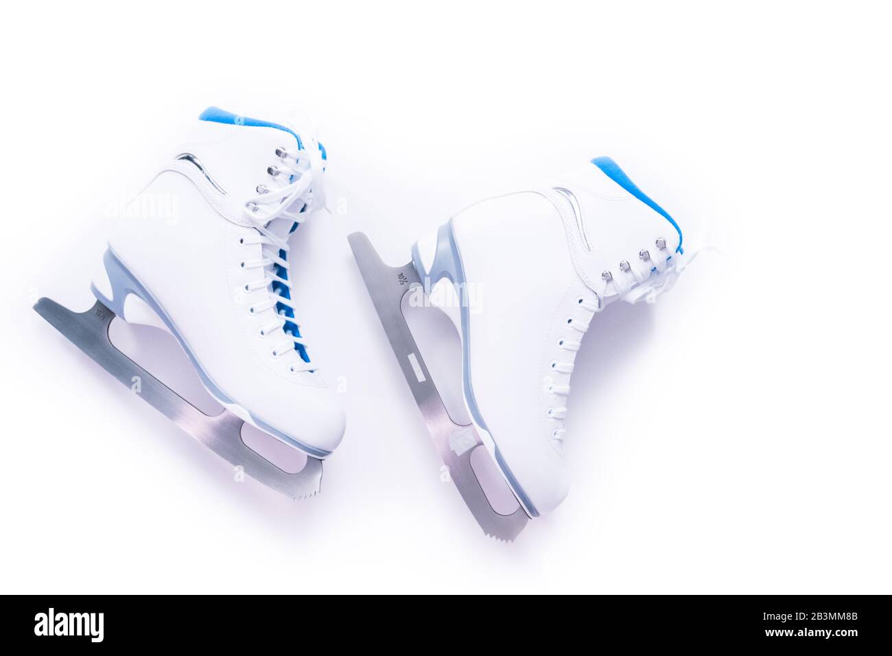 Flat lay. New white figure skates on a white background Stock Photo - Alamy