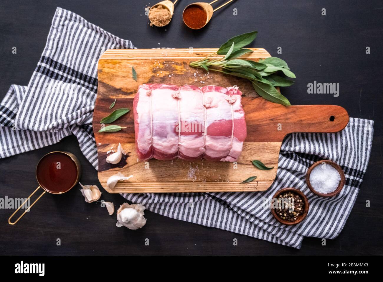 Flat lay. Uncooked boneless pork roast on the cutting board Stock Photo ...