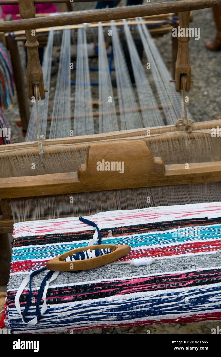 This is the old loom. Wood shuttle lays on multicolored homespun Stock ...