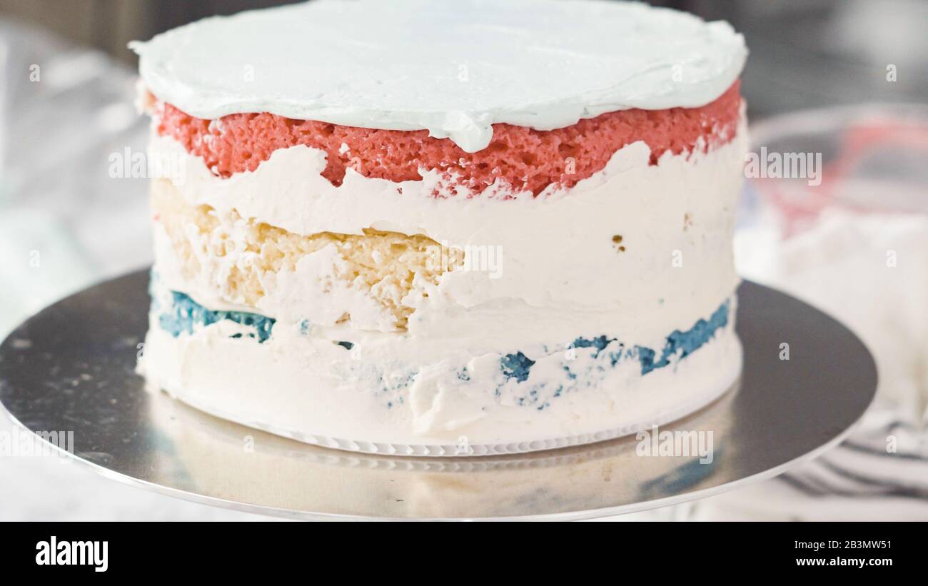Frosting round three-layer vanilla cake with buttercream frosting Stock ...