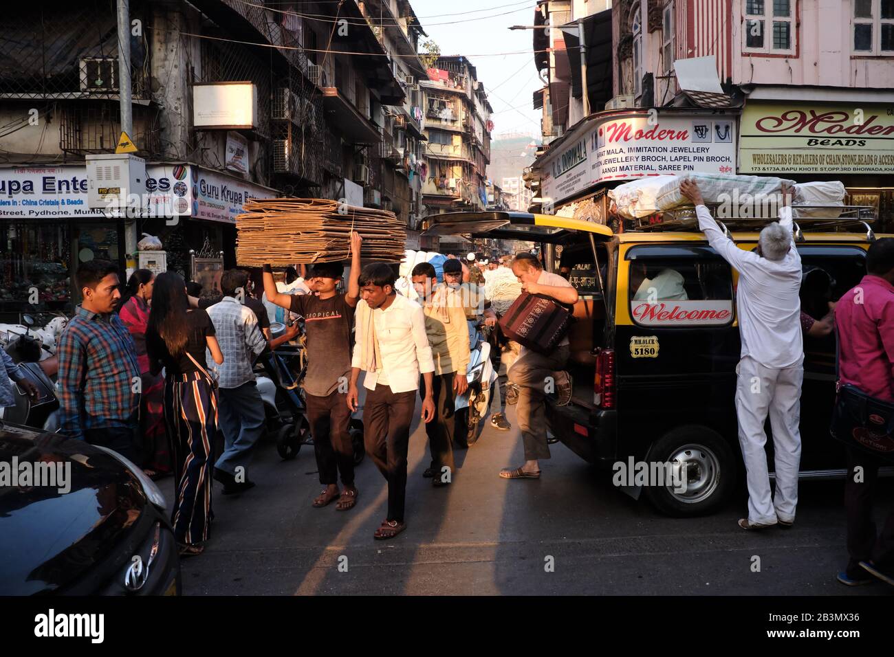 Crowds, porters and busy market activity in the narrow lanes of Bhendi ...