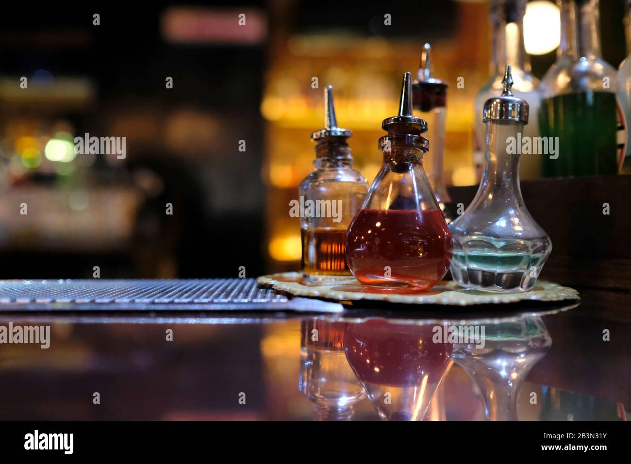 Colorful flasks on a cocktail bar counter Stock Photo - Alamy