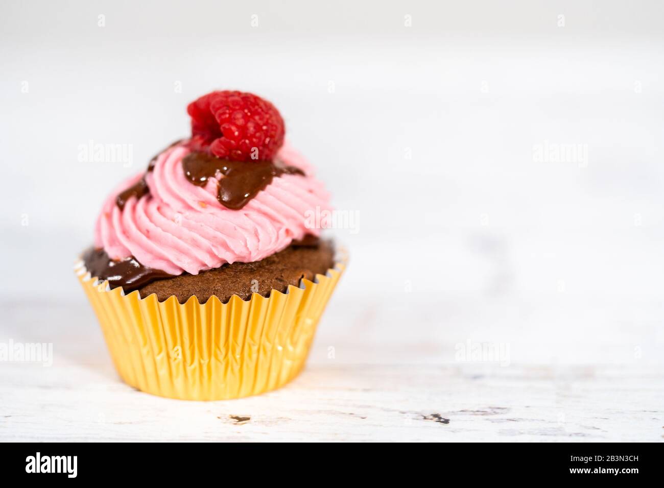 Gourmet chocolate raspberry cupcakes drizzled with chocolate ganache ...