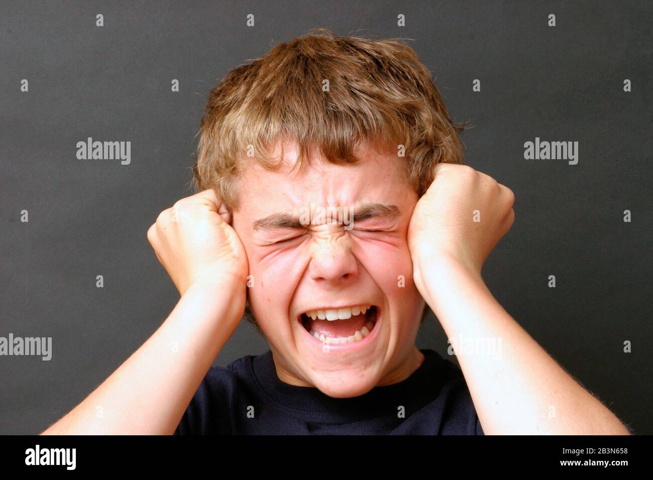 Portrait of boy aged 12 looking angry or annoyed UK Stock Photo - Alamy