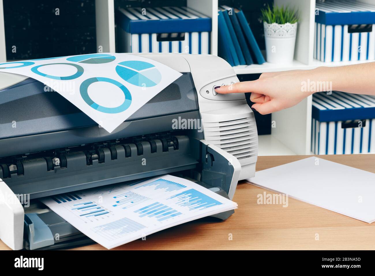 Female secretary making photocopies on xerox machine in office Stock ...