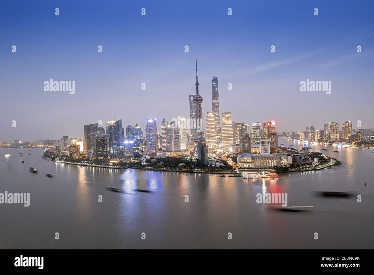 The illuminated skyline of Pudong district in Shanghai with the Huangpu ...