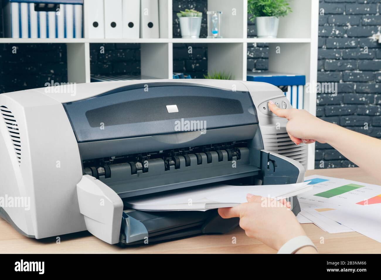 Woman making photocopy using copier in office Stock Photo - Alamy