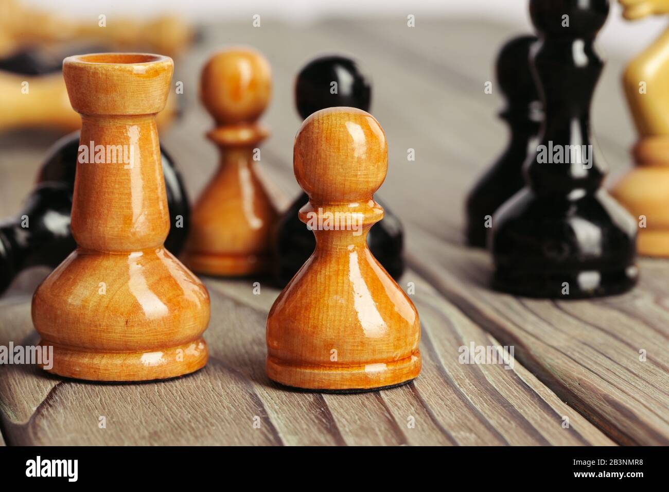 chess figures on brown woden table background Stock Photo - Alamy
