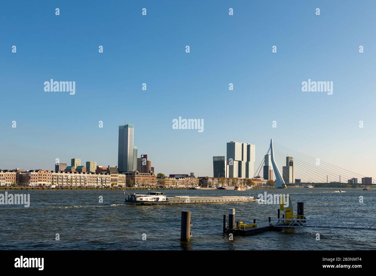 Skyline of Rotterdam over the Maas river with a boat in the Netherlands ...
