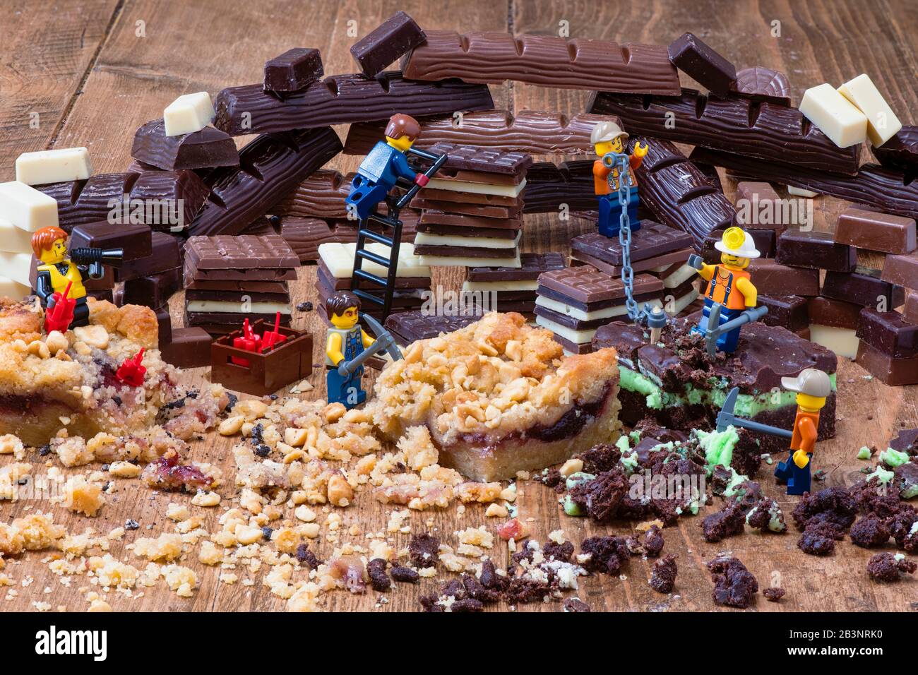 Chocolate and cake mining. Toy Lego men with cake and chocolate Stock ...
