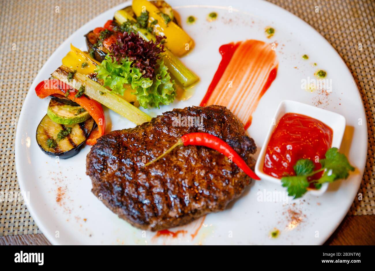 Medium-sized steak with vegetables in a cafe Stock Photo - Alamy