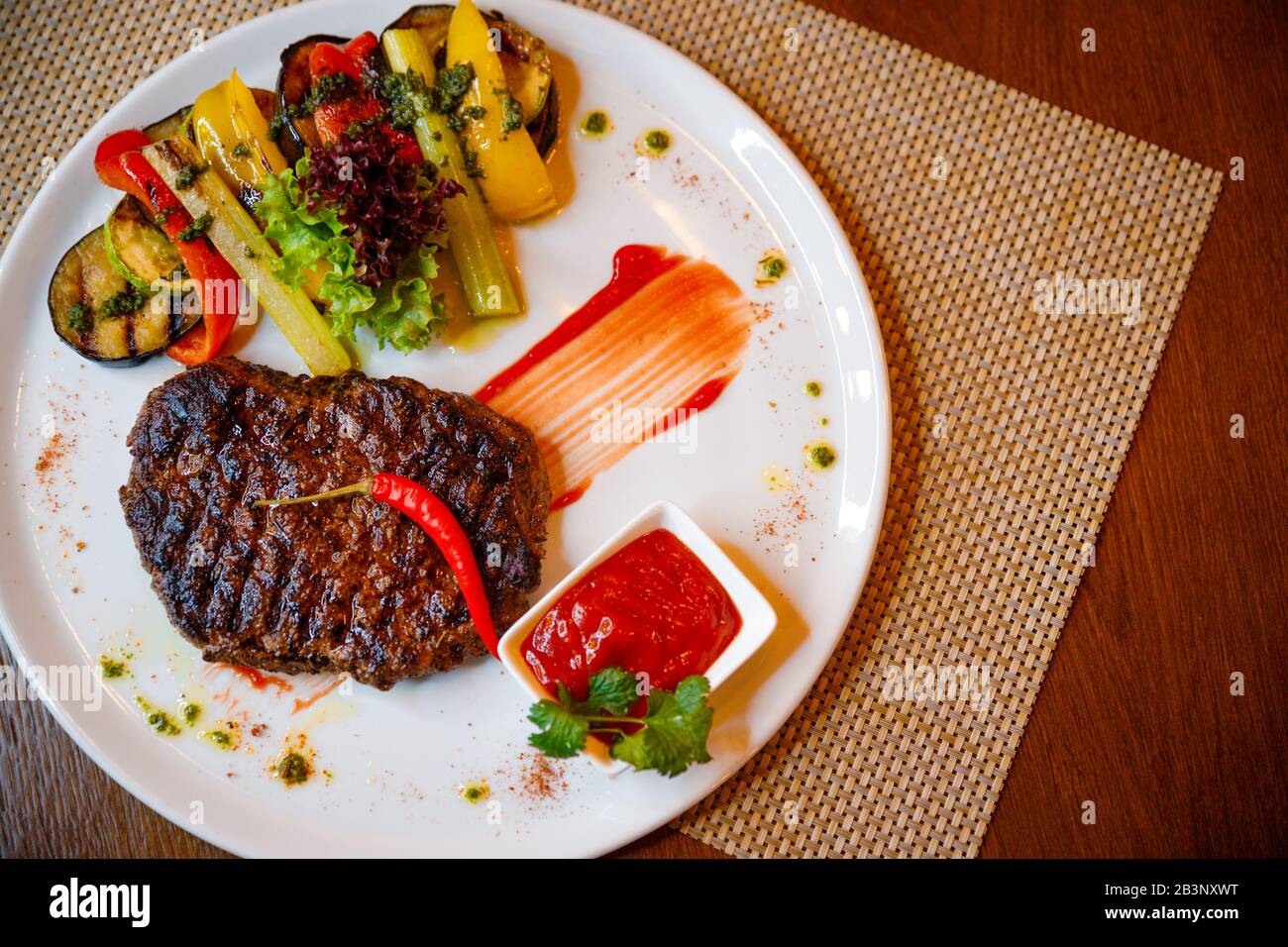 Medium-sized steak with vegetables in a cafe Stock Photo - Alamy