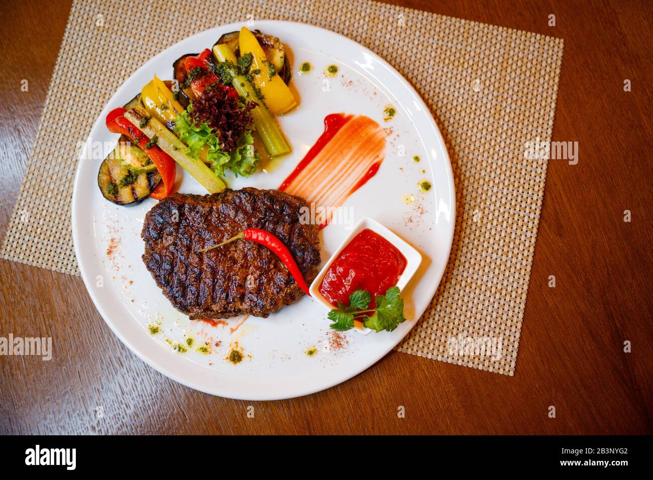 Medium-sized steak with vegetables in a cafe Stock Photo - Alamy