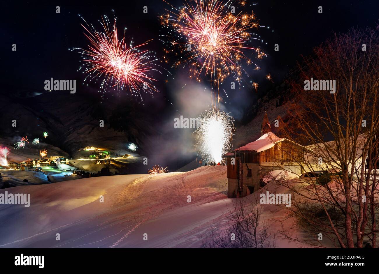 The Austrian ski resort Warth in the snowy Alps with New Year rockets ...