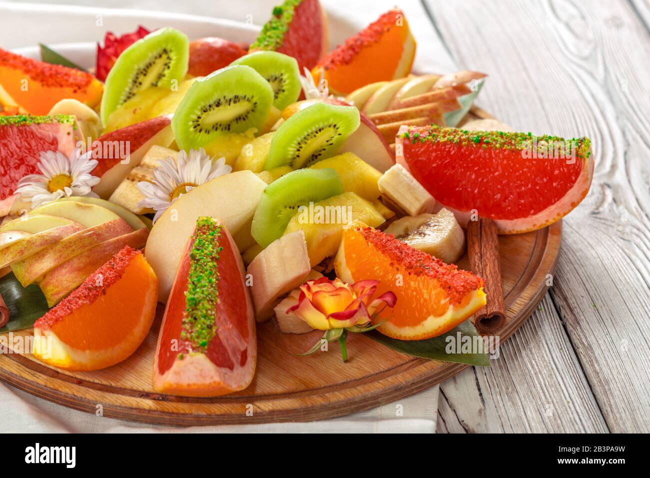 Assorted sliced tropical fruits on plate hi-res stock photography and ...