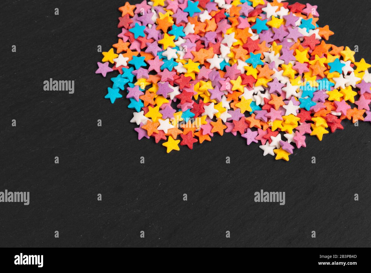 Colored star shaped candy sugar sprinkles as a background Stock Photo ...