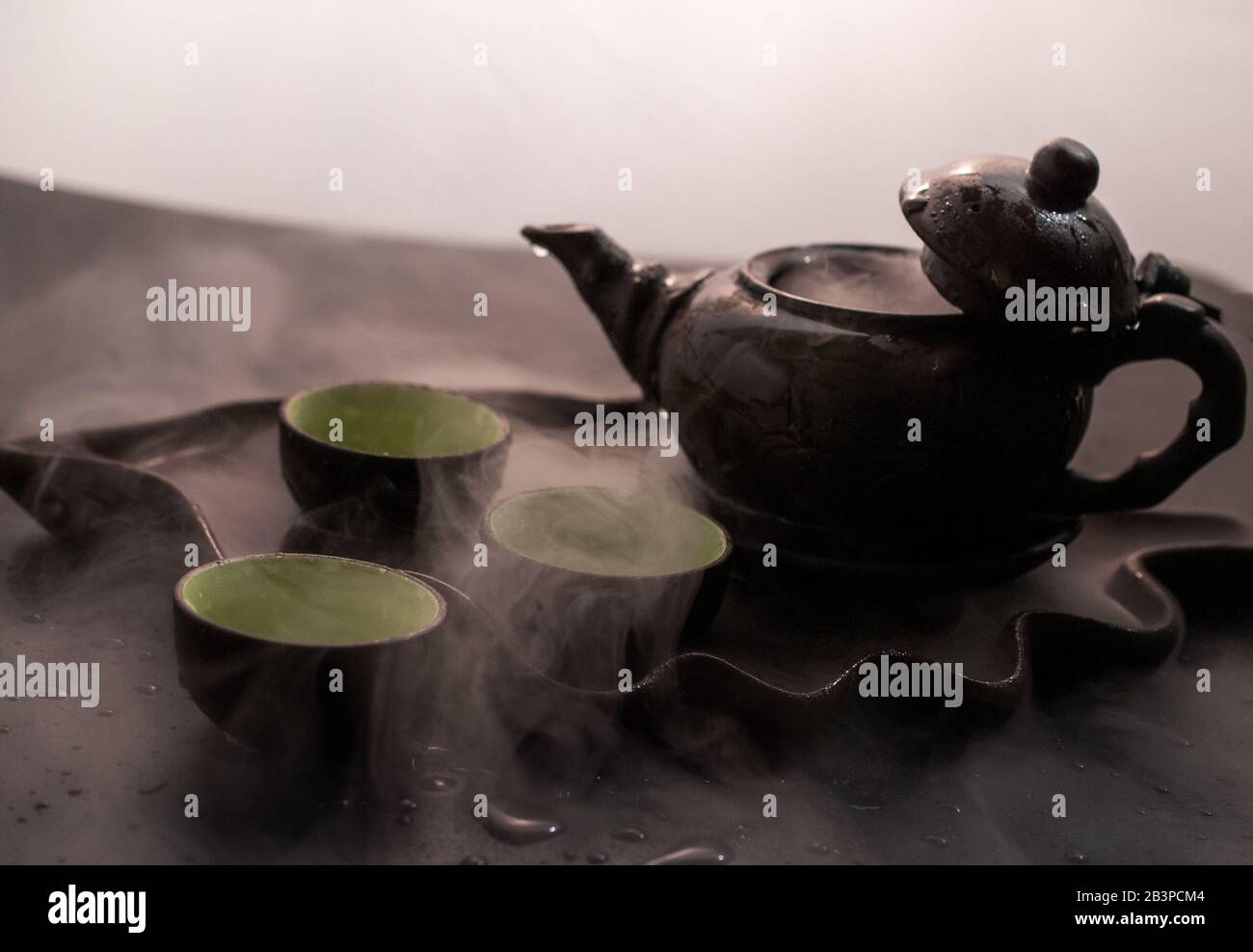 brown teapot set under smoke Stock Photo - Alamy