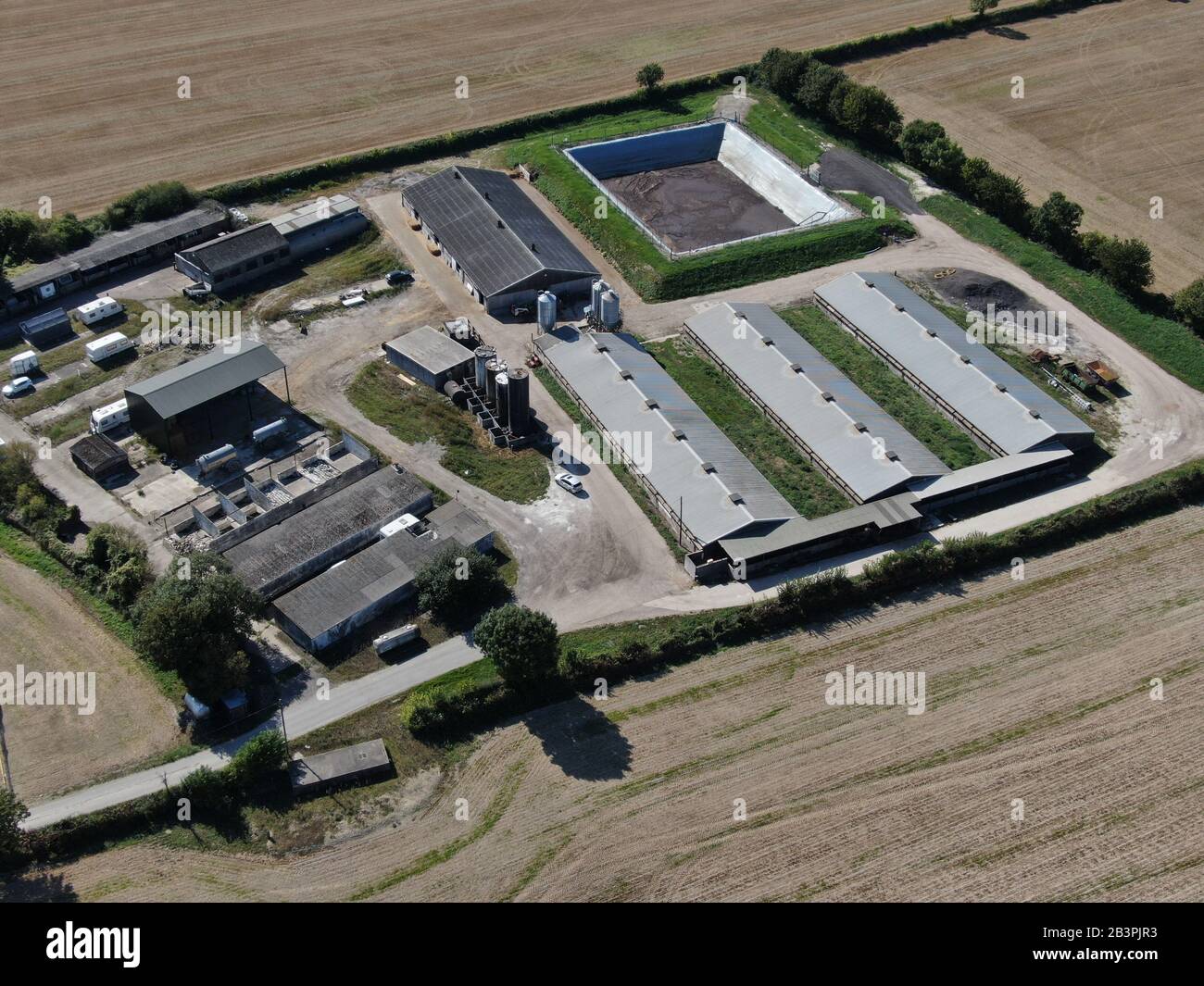 aerial view of modern farm yard showing neat buildings and surrounded ...