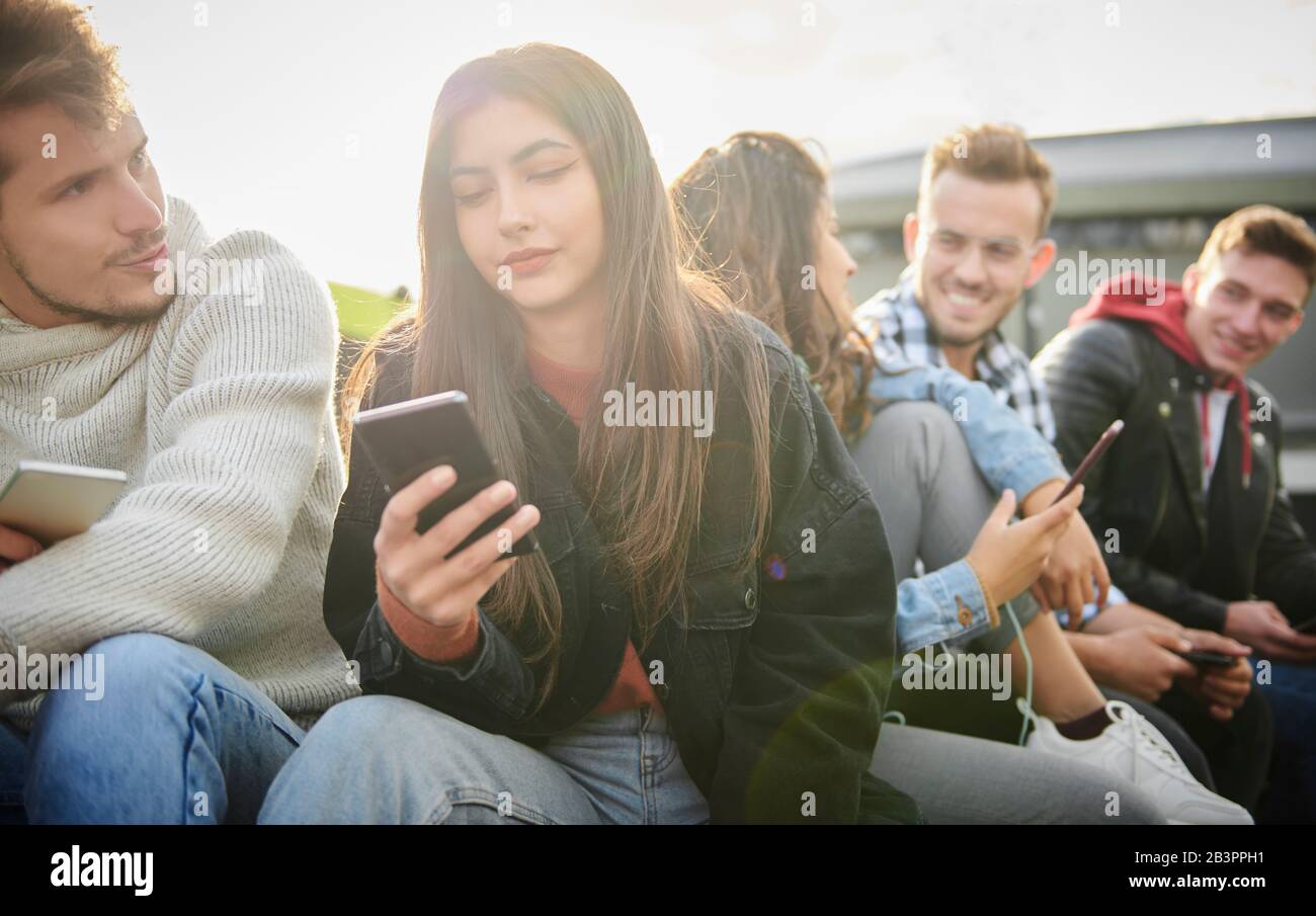 Young people who use mobile phone Stock Photo - Alamy