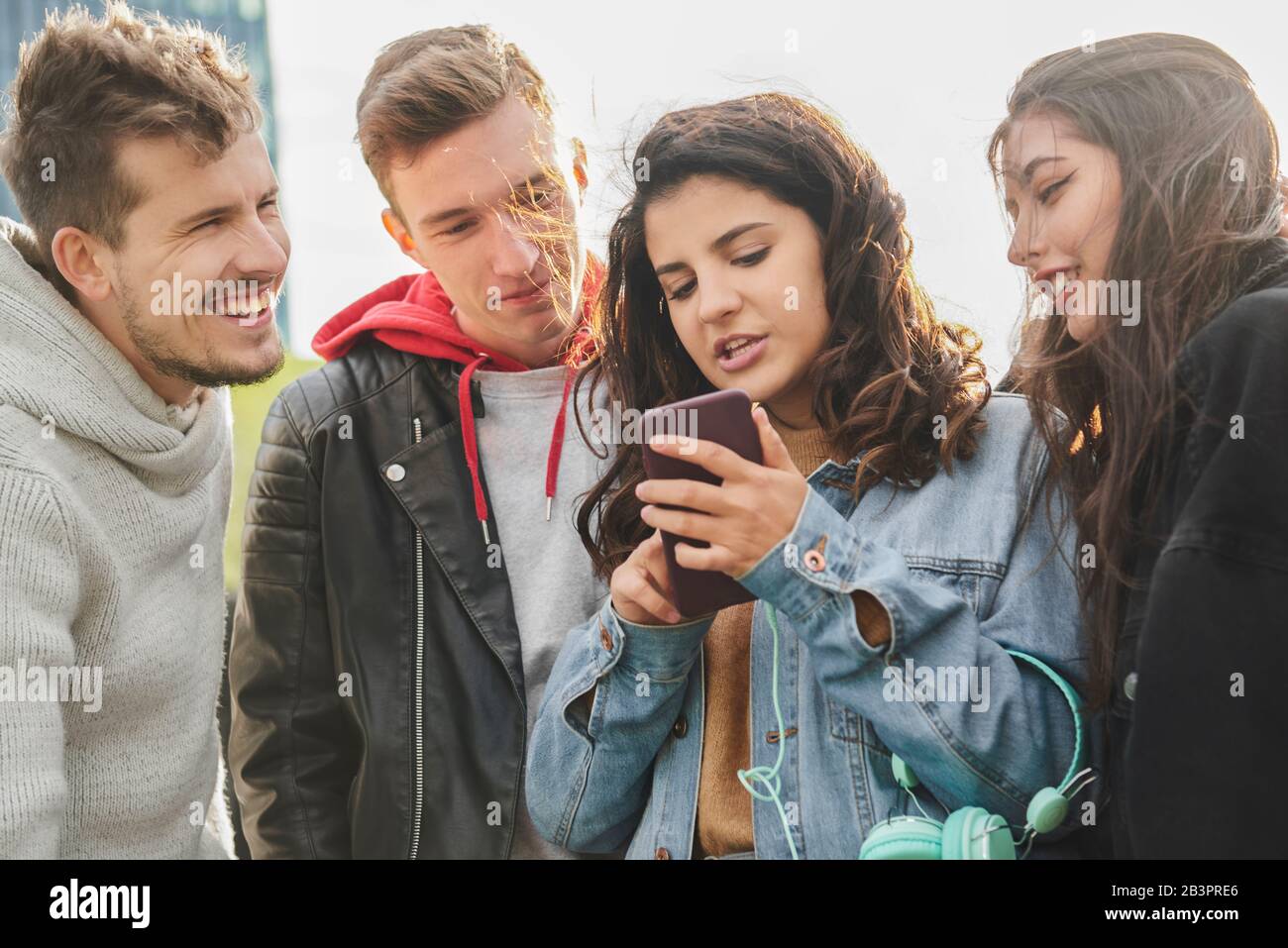 Young woman showing something on her mobile phone Stock Photo - Alamy
