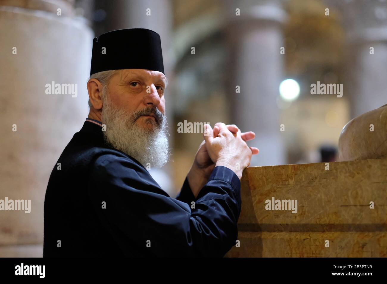 A Greek orthodox priest inside the Church of the Holy Sepulchre in the ...
