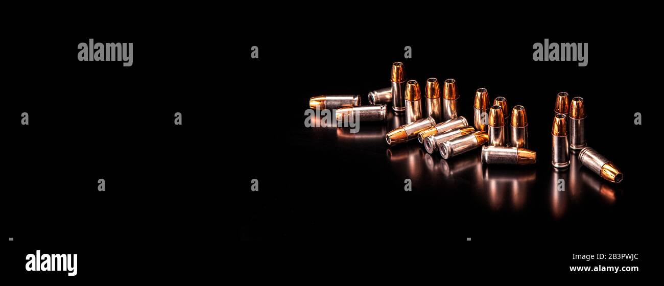 Bullet isolated on black background with reflexion. Rifle bullets close ...